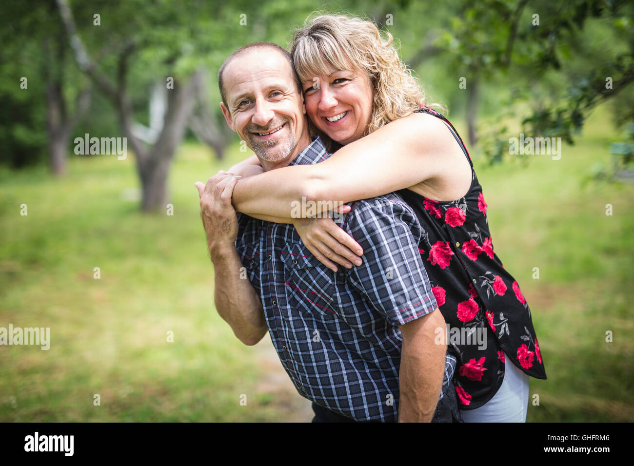 Happy adult couple in park Stock Photo - Alamy
