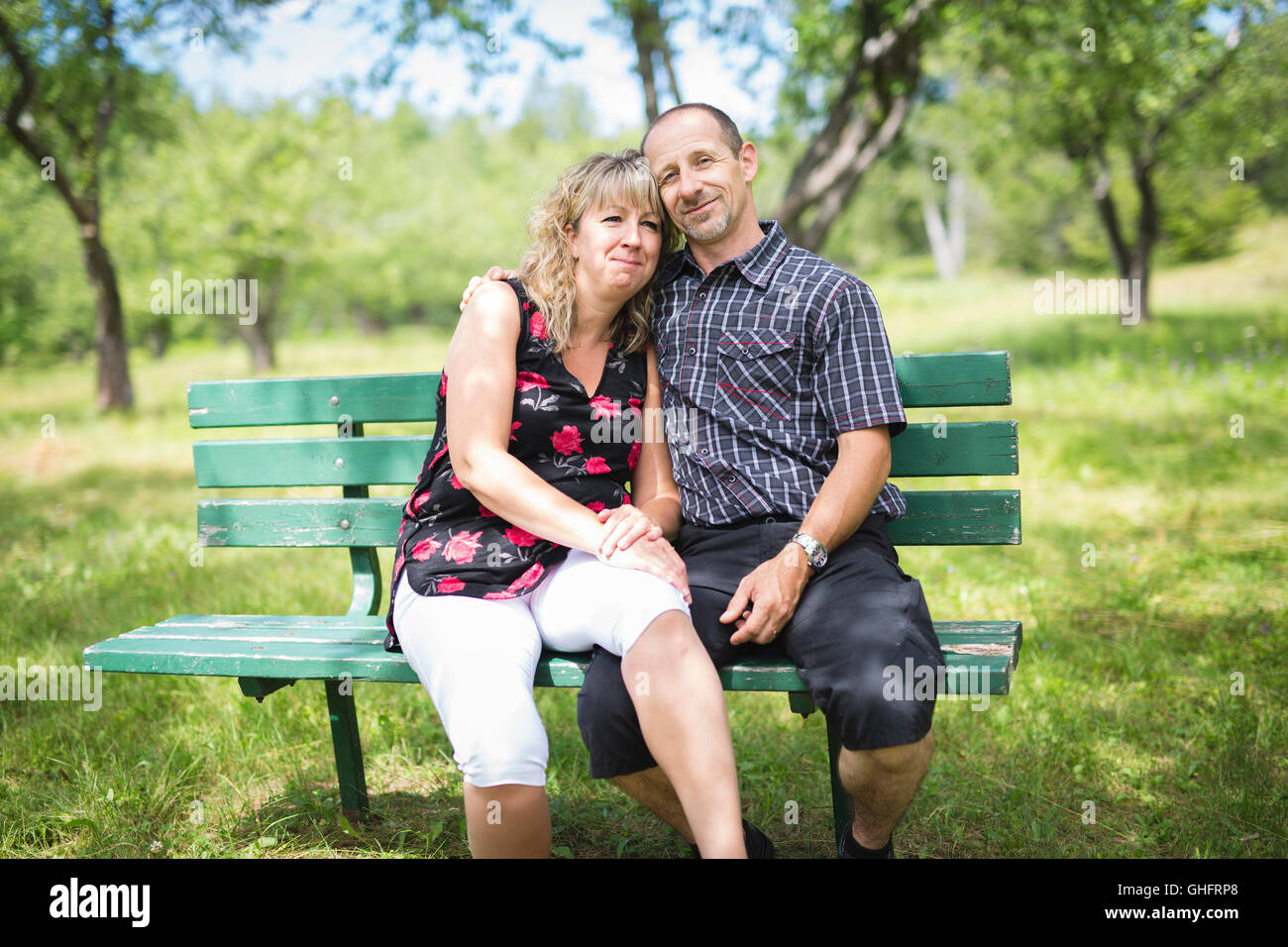Happy adult couple in park Stock Photo - Alamy