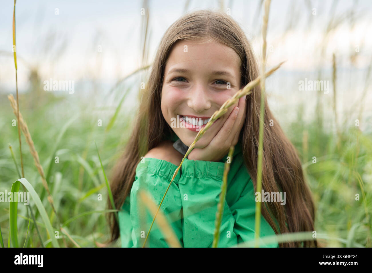 Girl enjoying the rain and having fun outside on the beach a gray rainy ...