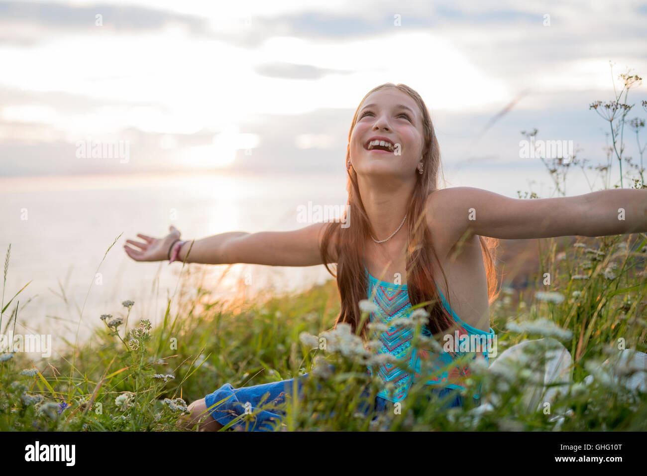 Teenager girl at sunset on the side of the sea Stock Photo - Alamy