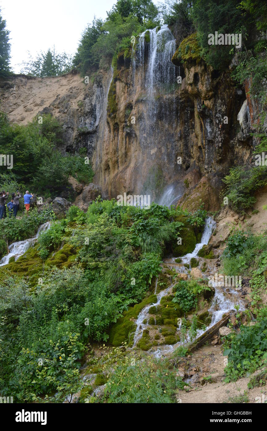 A group of tourists near a waterfall Stock Photo - Alamy