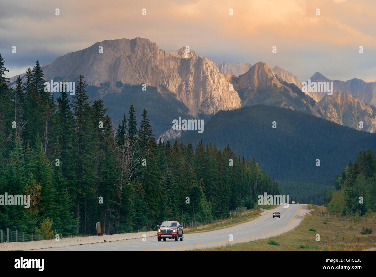 Highway in Banff national park at sunset with mountains and forest in ...
