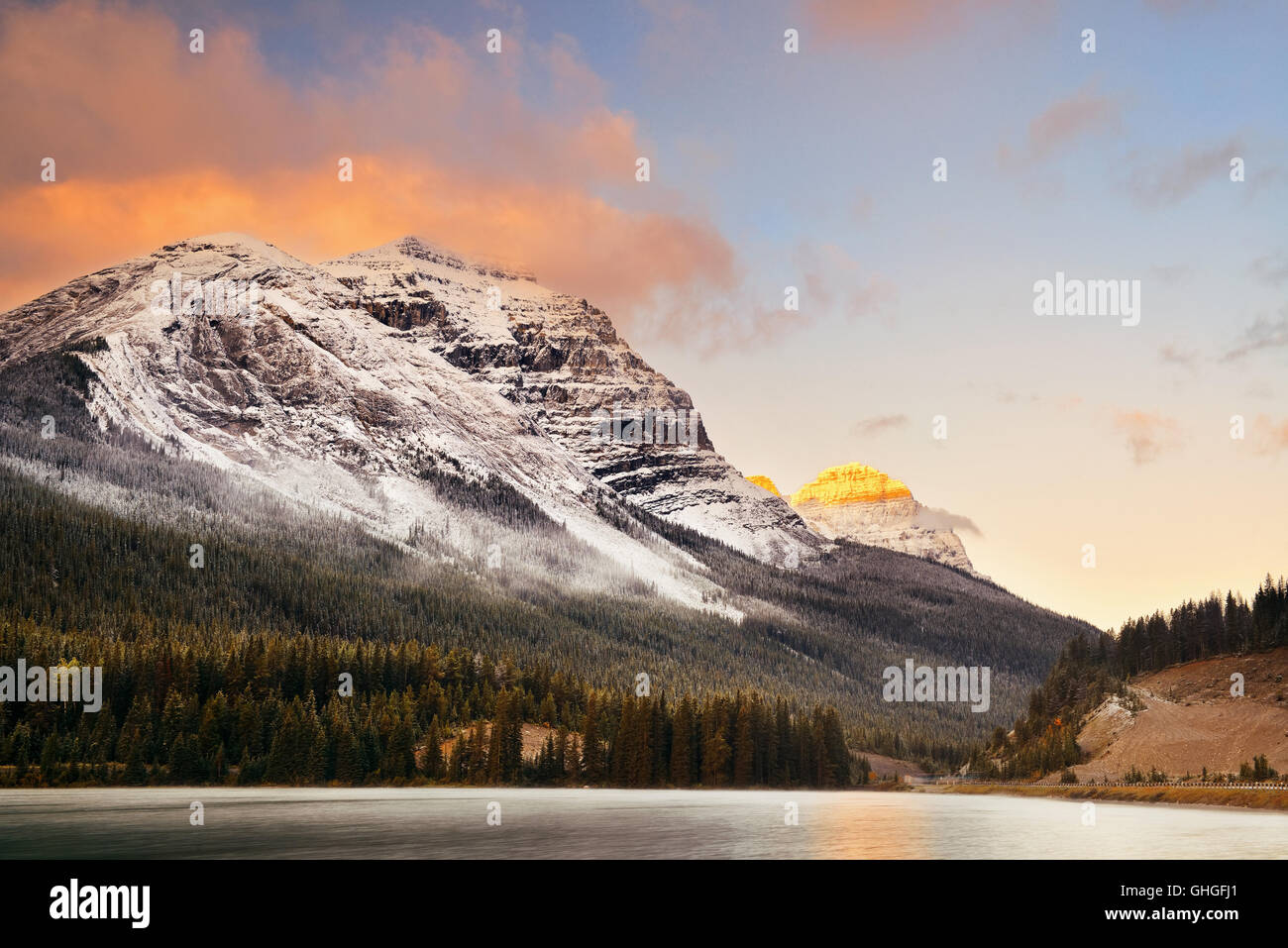 Mountain lake with reflection and fog at sunset in Banff National Park ...