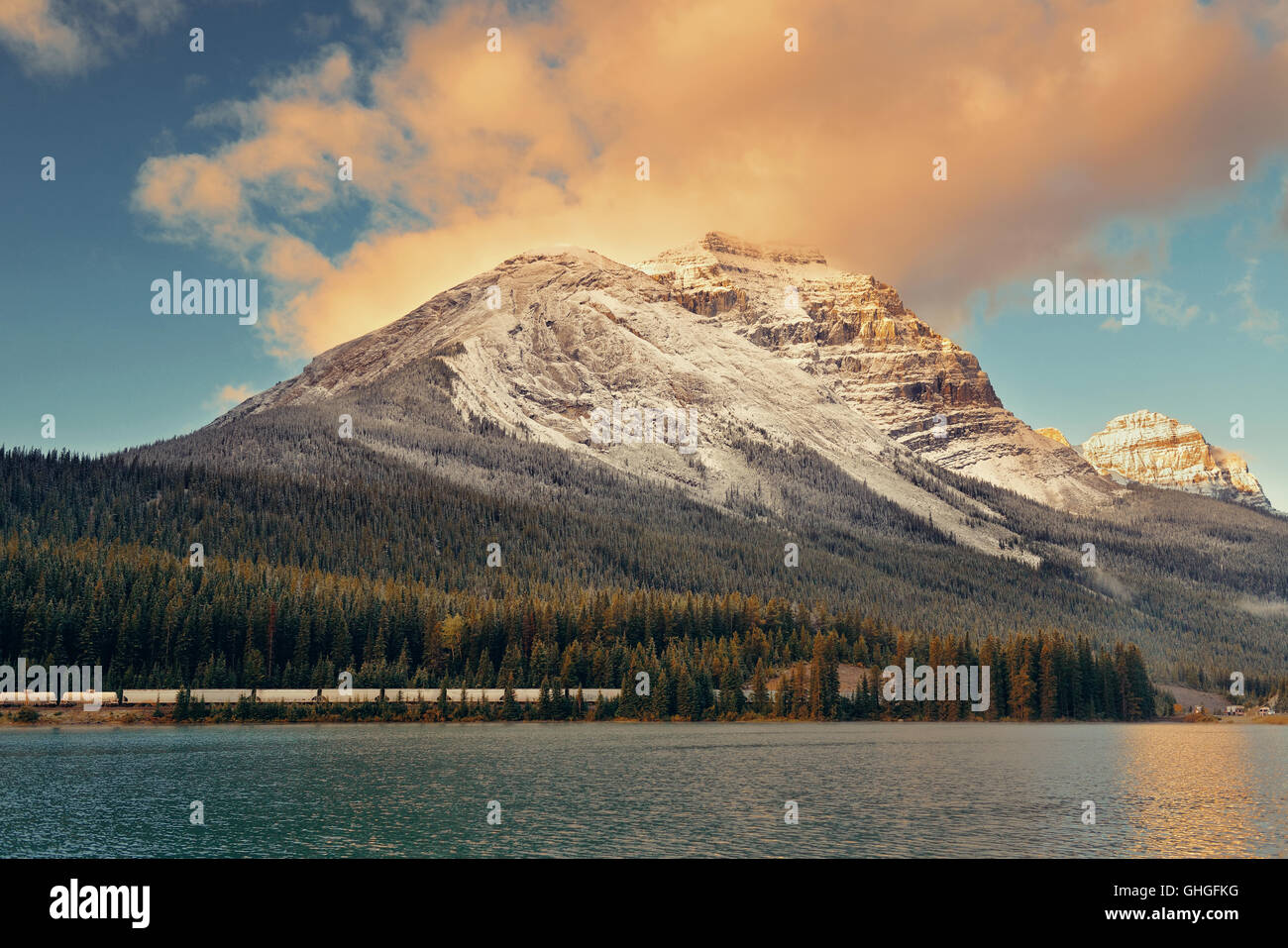 Mountain lake with reflection and fog at sunset in Banff National Park ...