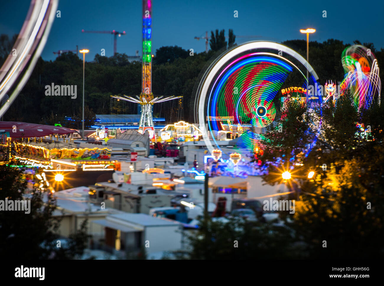 Carousels spin on the public festival Dippemess (long exposure image ...
