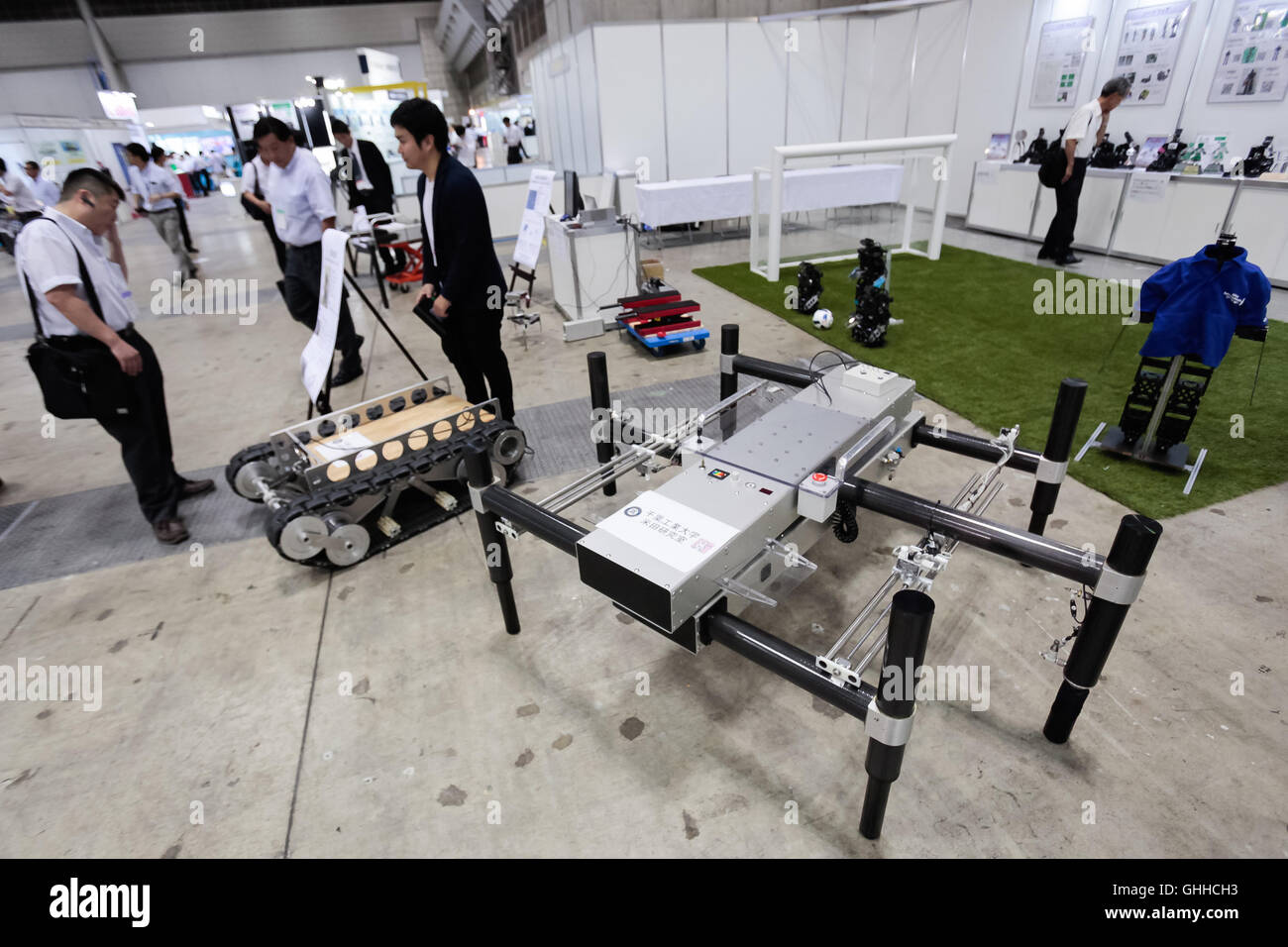 Tokyo, Japan. 28th September, 2016. Visitors look at robots on display ...