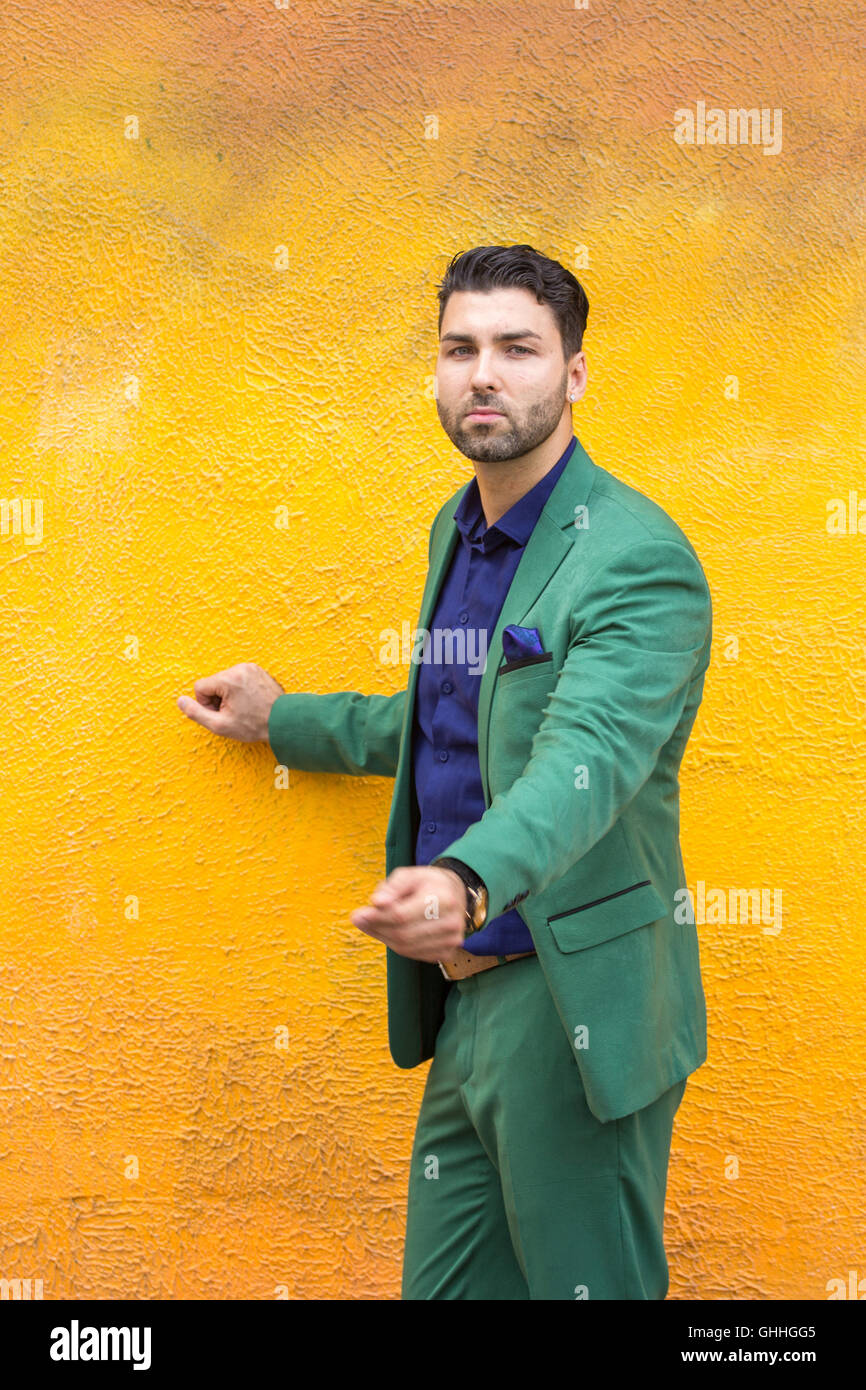 Hipster fashion man, street style, blogger. Man in gren suit on yellow ...