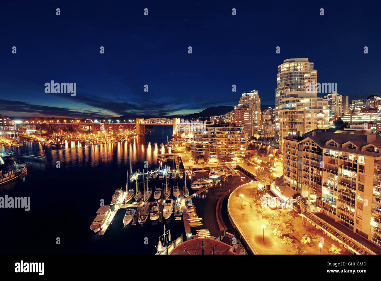 Vancouver harbor view with urban apartment buildings and bay boat at ...