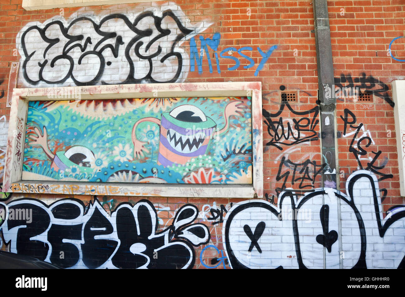 Colorful urban art and youth tagging on old brick building exterior in ...