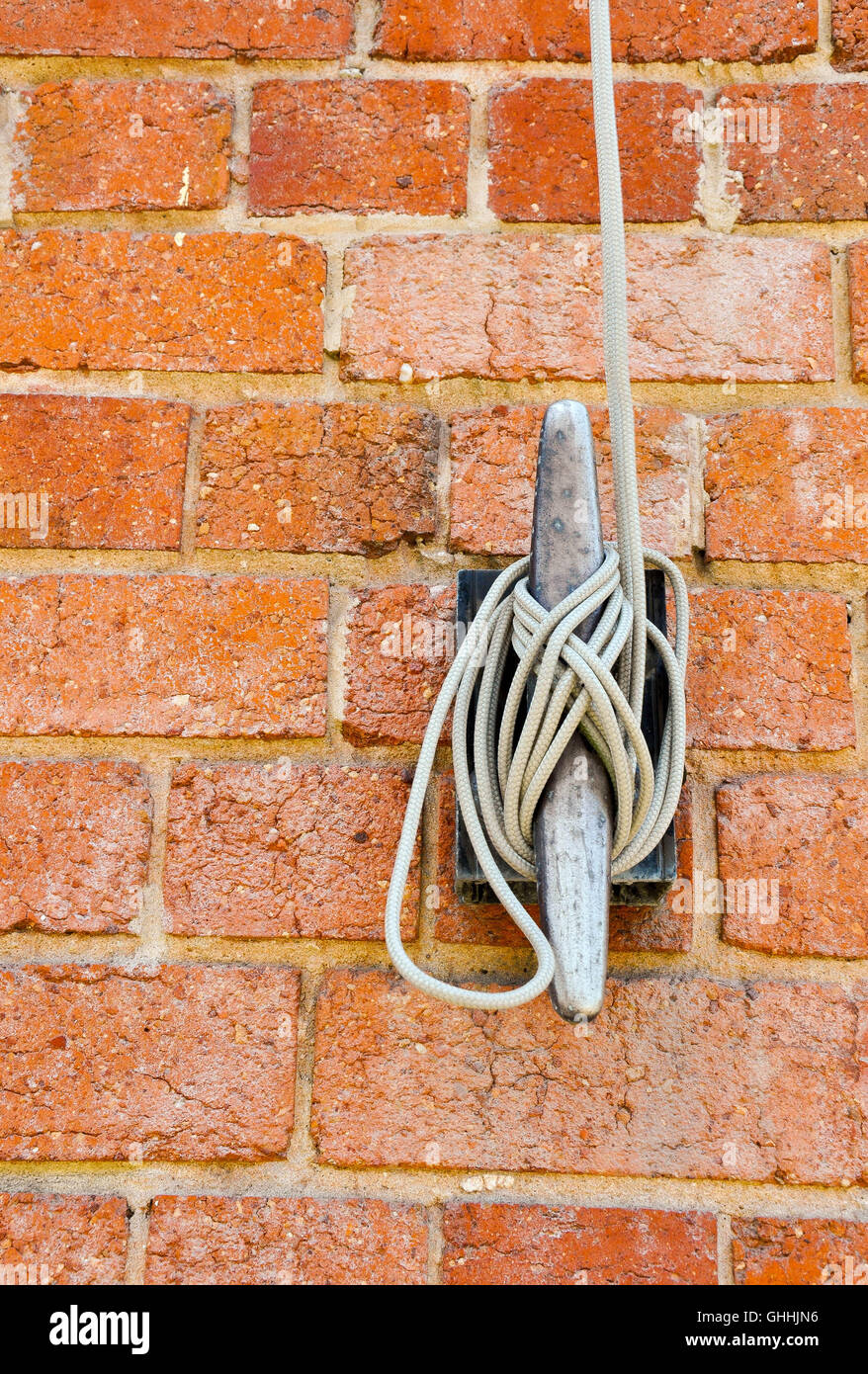 Closeup of outdoor metal cleat on red brick exterior wall with flag ...
