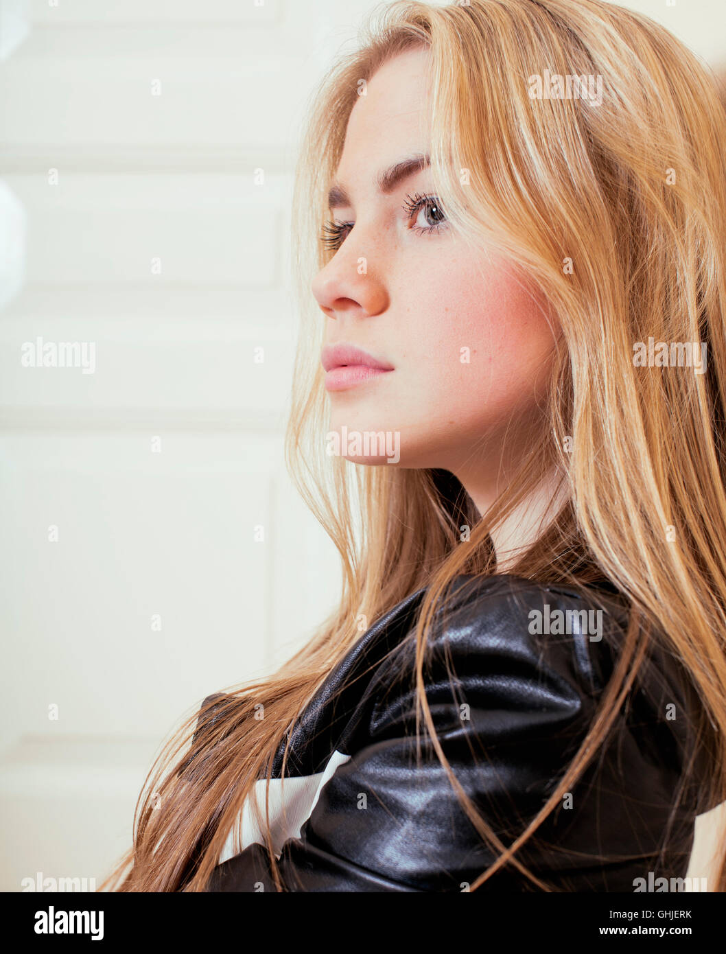 young pretty teenage blond girl sitting on floor at home despair sad ...