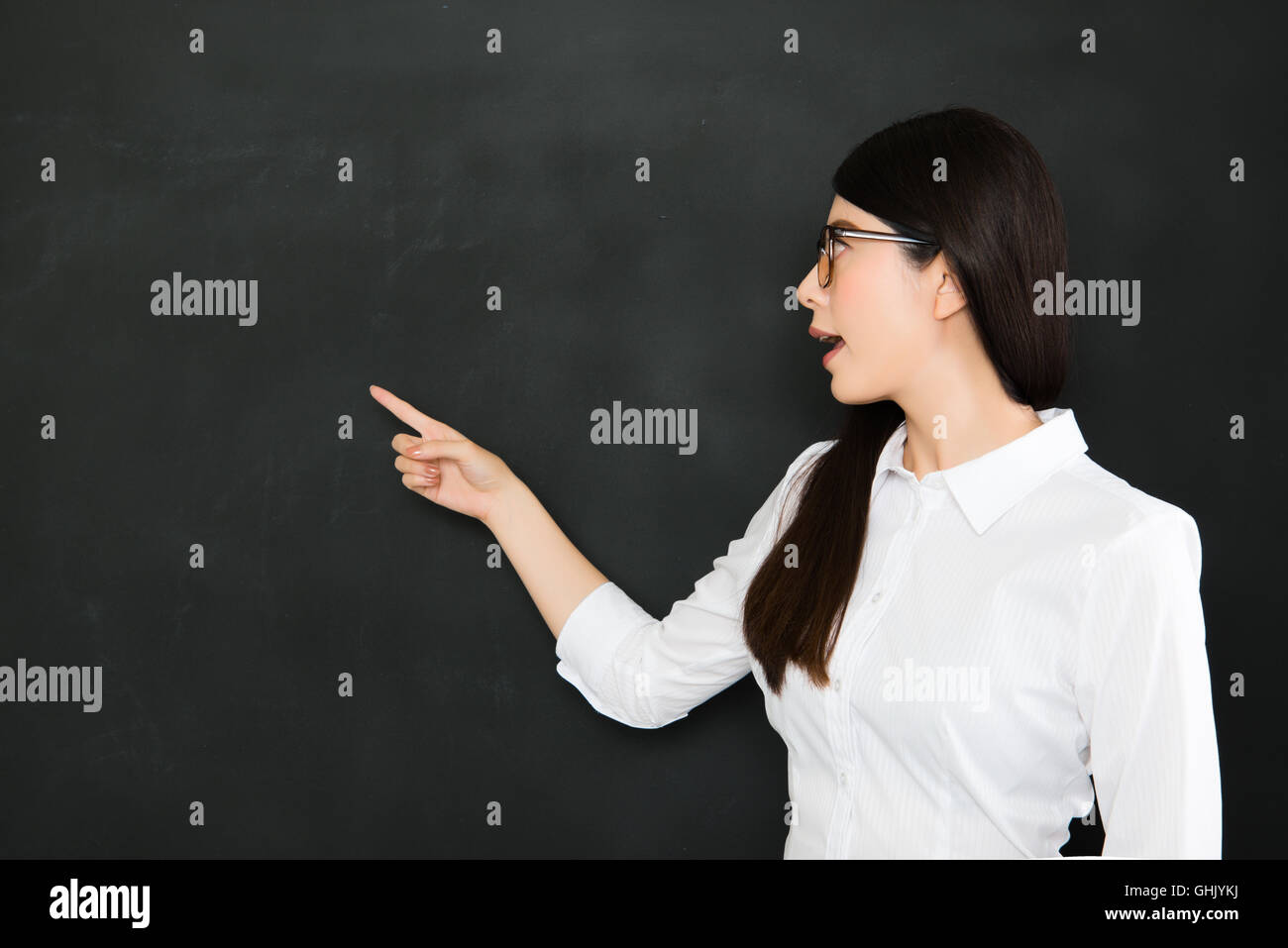 young asian teacher pointing a question on blackboard in school Stock ...