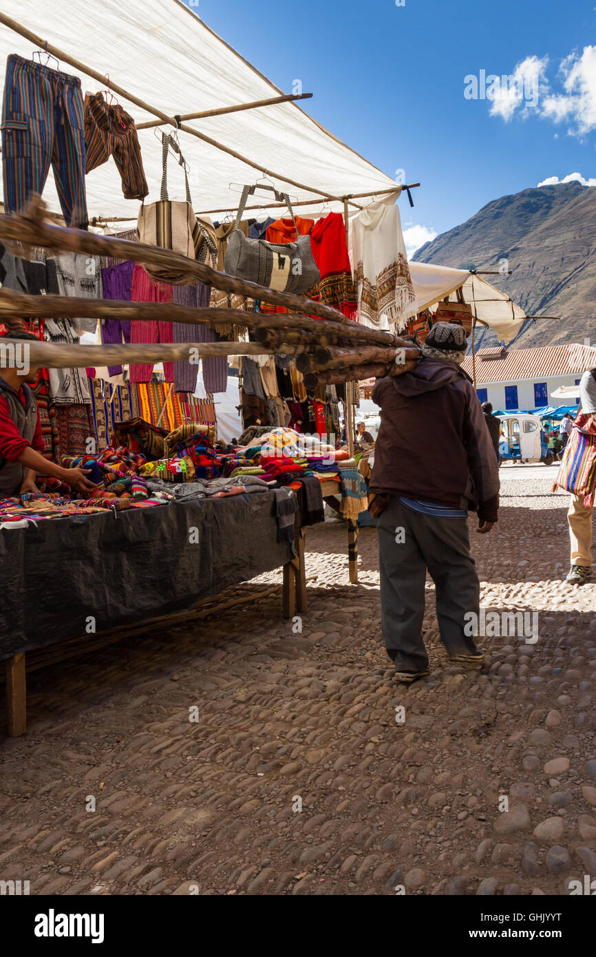 Pisac, Peru - May 15: Peruvian man carrying poles to build a tent in ...
