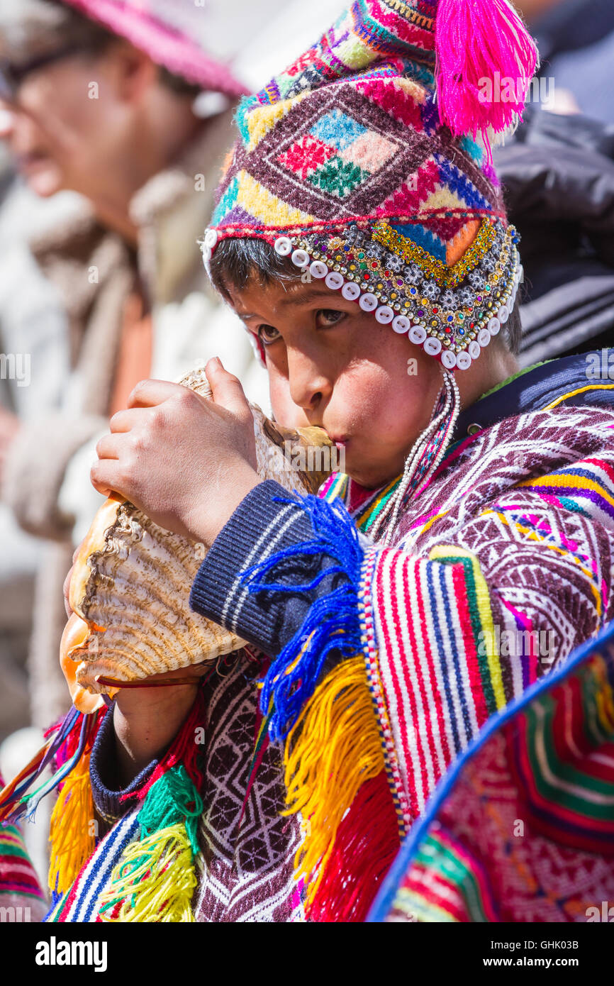 Pisac, Peru - May 15: Young man playing a tune using a conch shell as ...