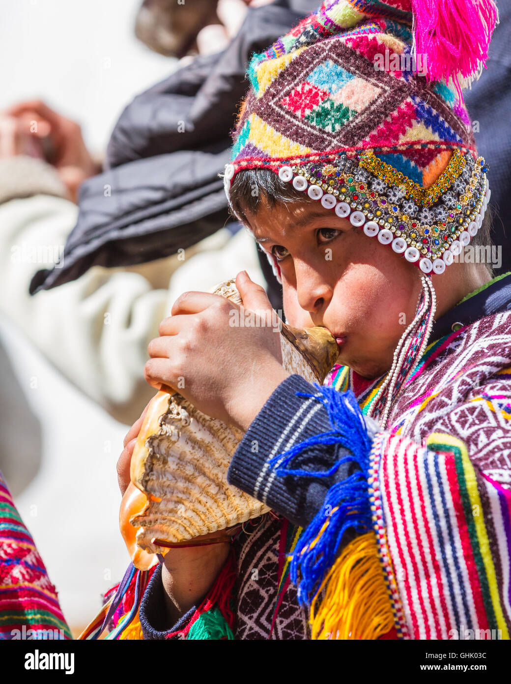 Pisac, Peru - May 15: Young man playing a tune using a conch shell as ...