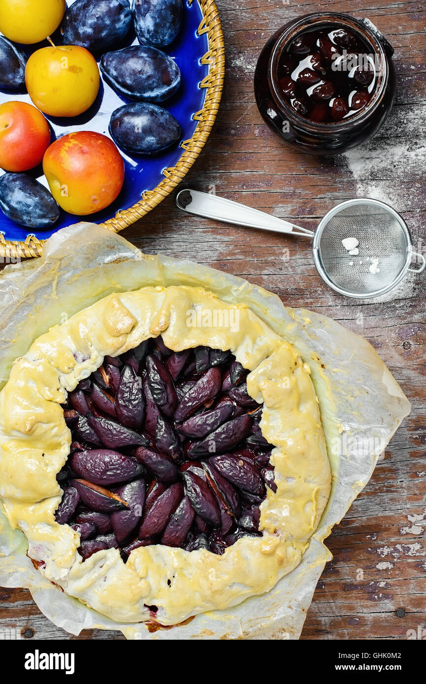 Rustic pie with plums and plum jam on wooden background Stock Photo - Alamy