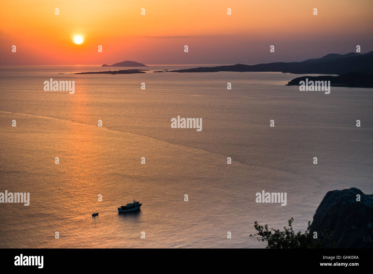 Sunset at sea, with small greek islands in background, Sithonia Stock ...