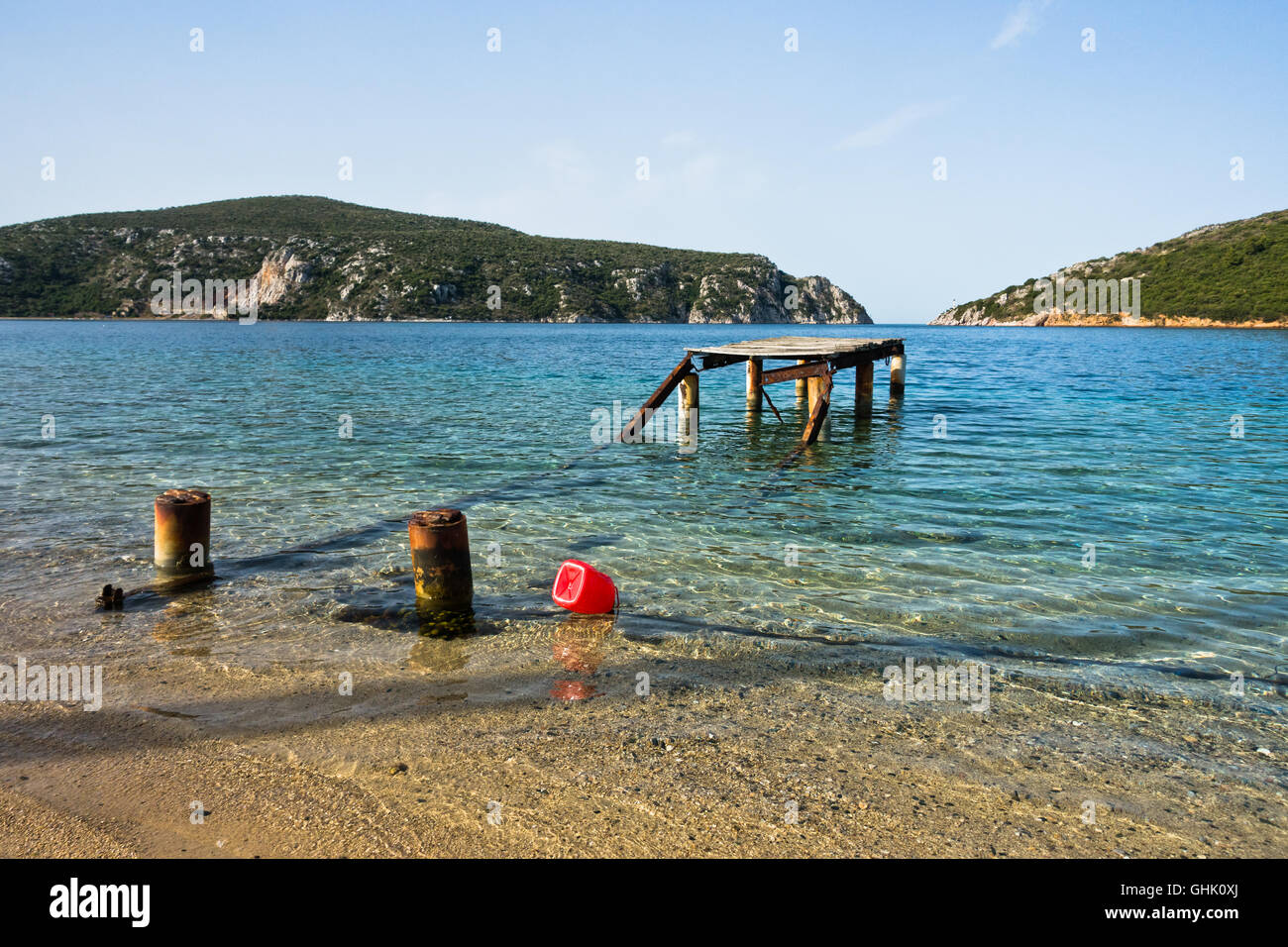 Old rusty wooden dock at sunny morning, Porto Koufo harbor Stock Photo ...
