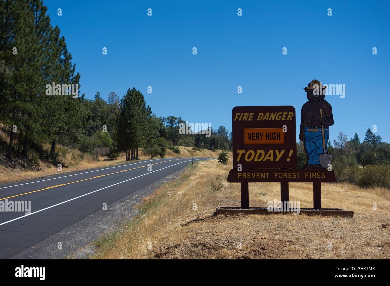 Very high risk of fire warning sign on side of road with figure of Yogi ...