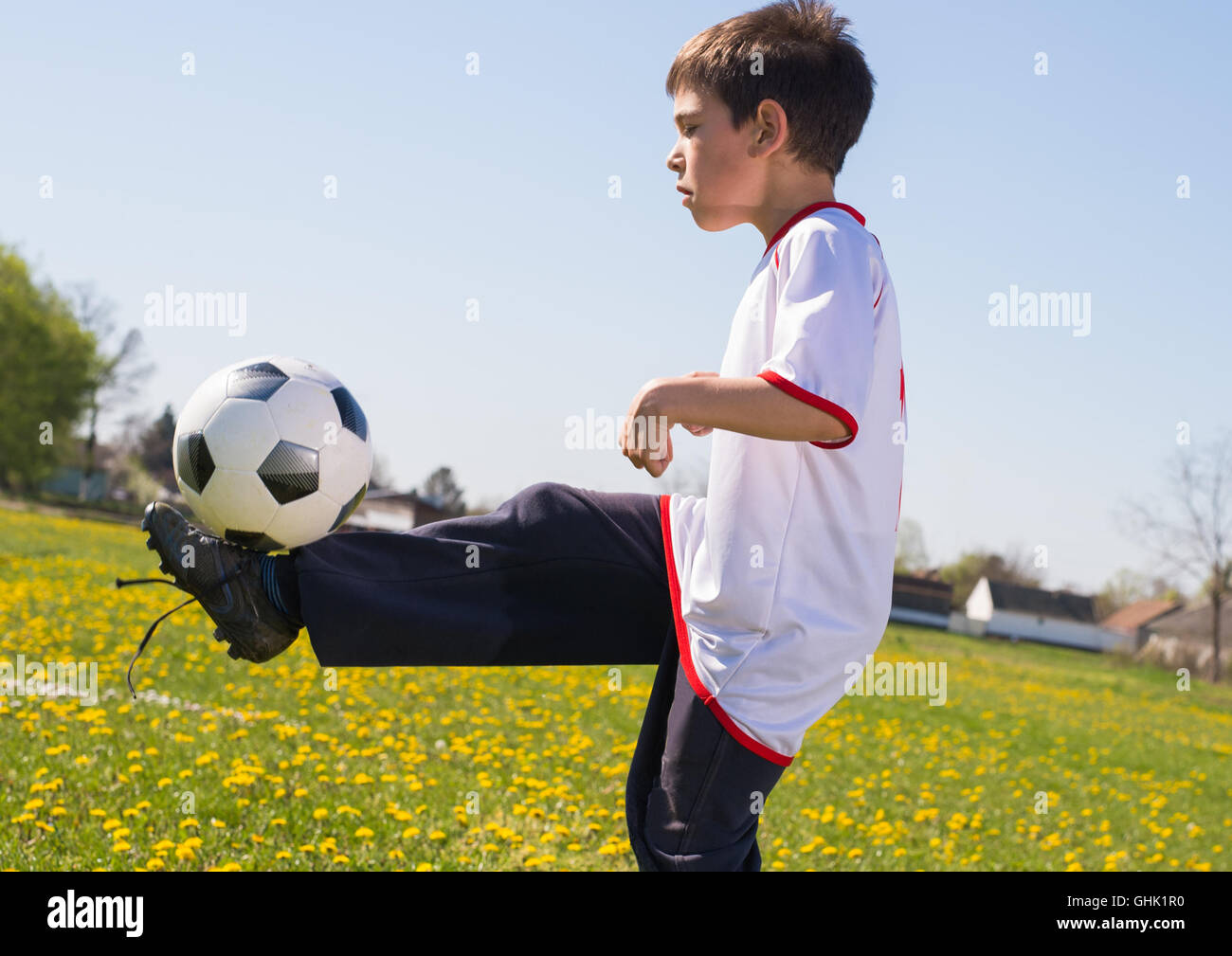 Boys kicking football on the field Stock Photo - Alamy