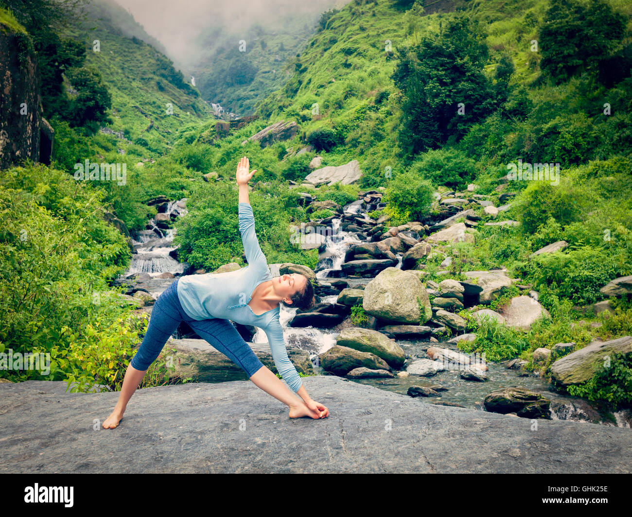Woman doing Ashtanga Vinyasa yoga asana Utthita trikonasana Stock Photo ...