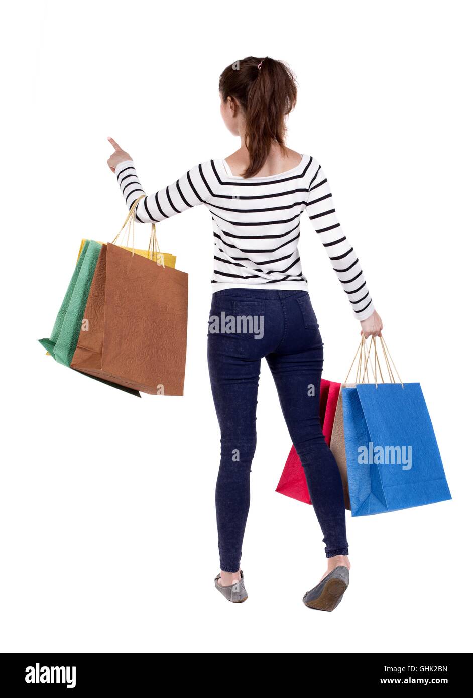 back view of woman with shopping bags pointing Stock Photo - Alamy