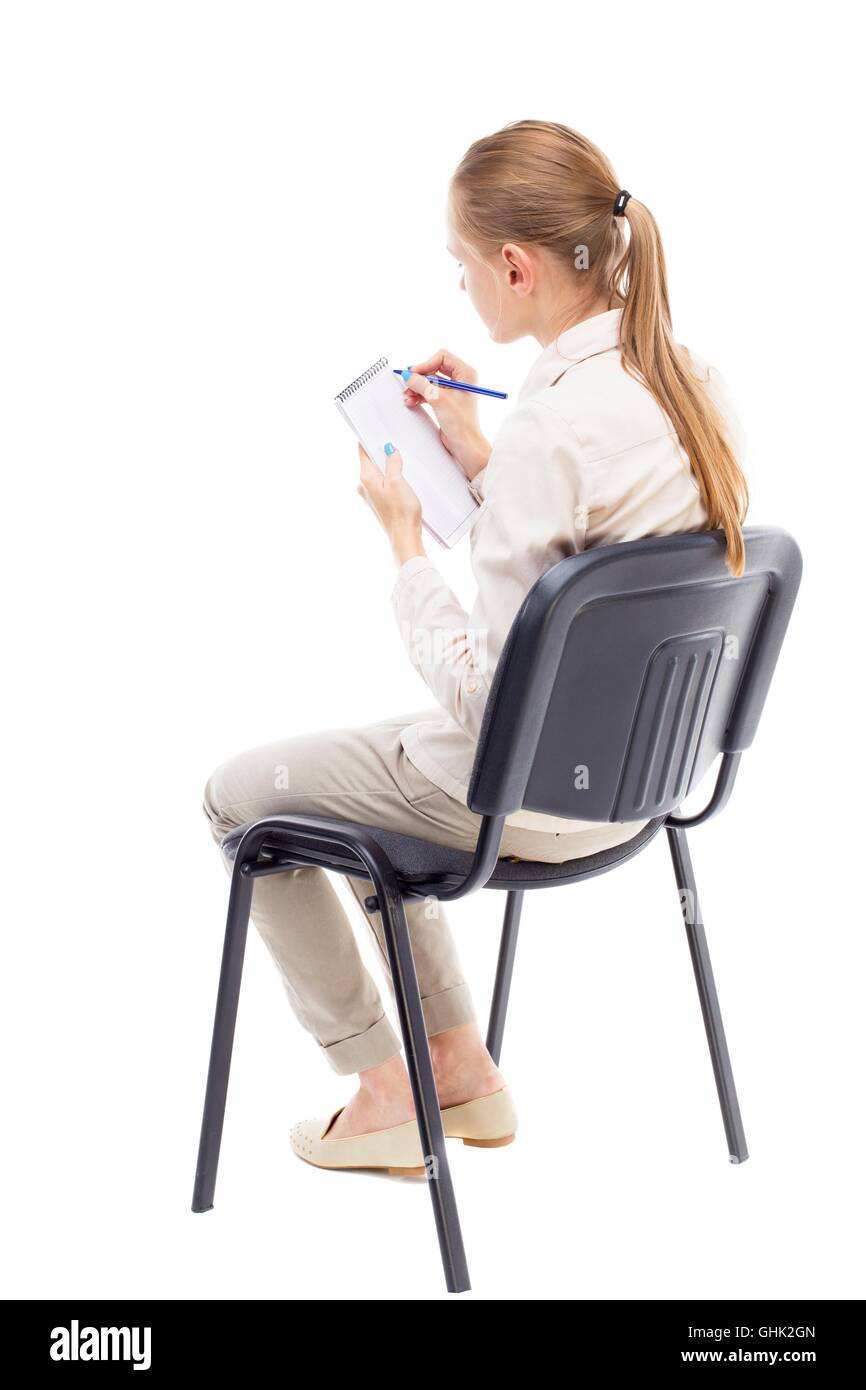 back view of young beautiful woman sitting on chair and takes Stock ...