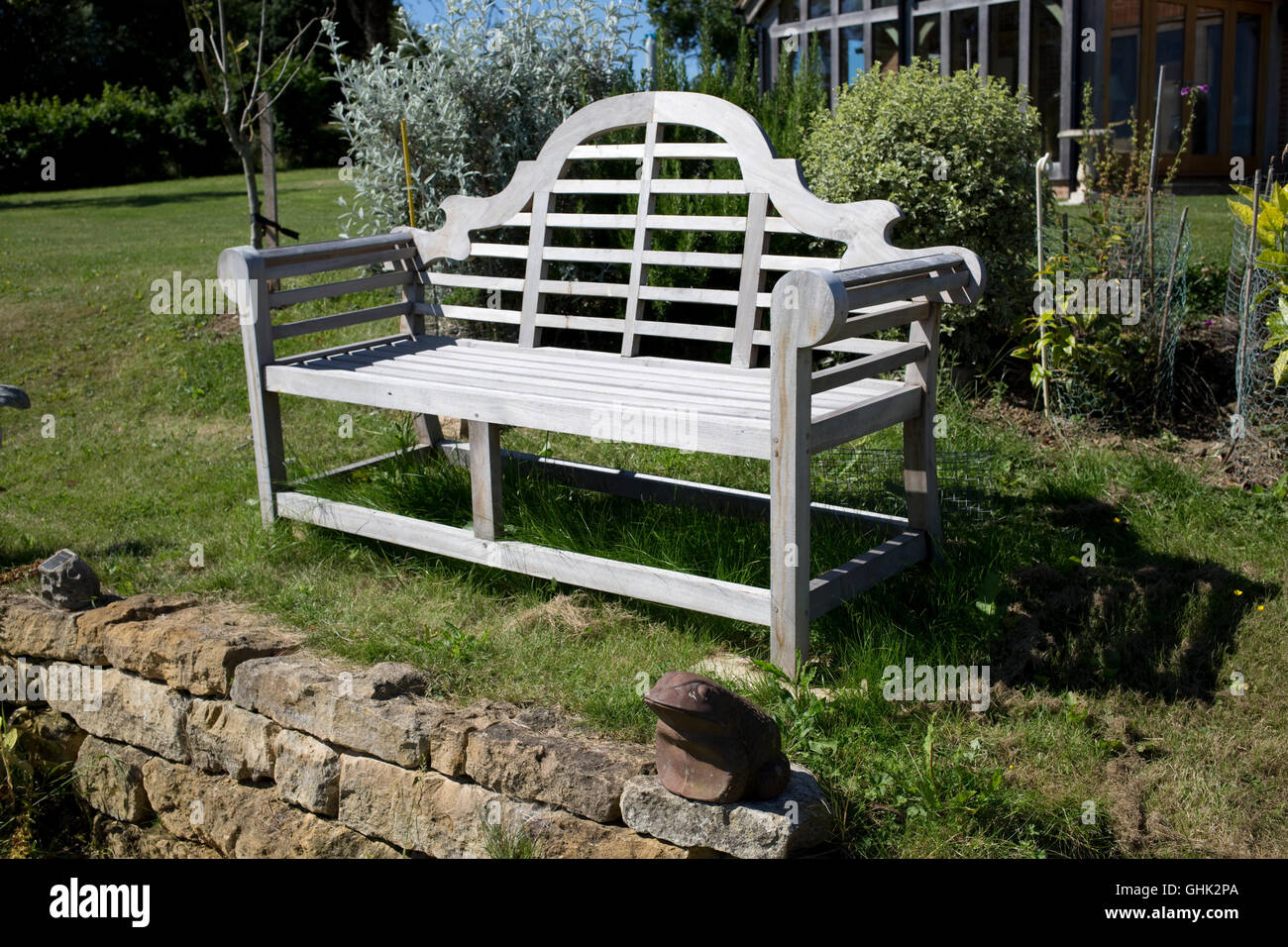Three seater rustic wooden garden seat UK Stock Photo - Alamy