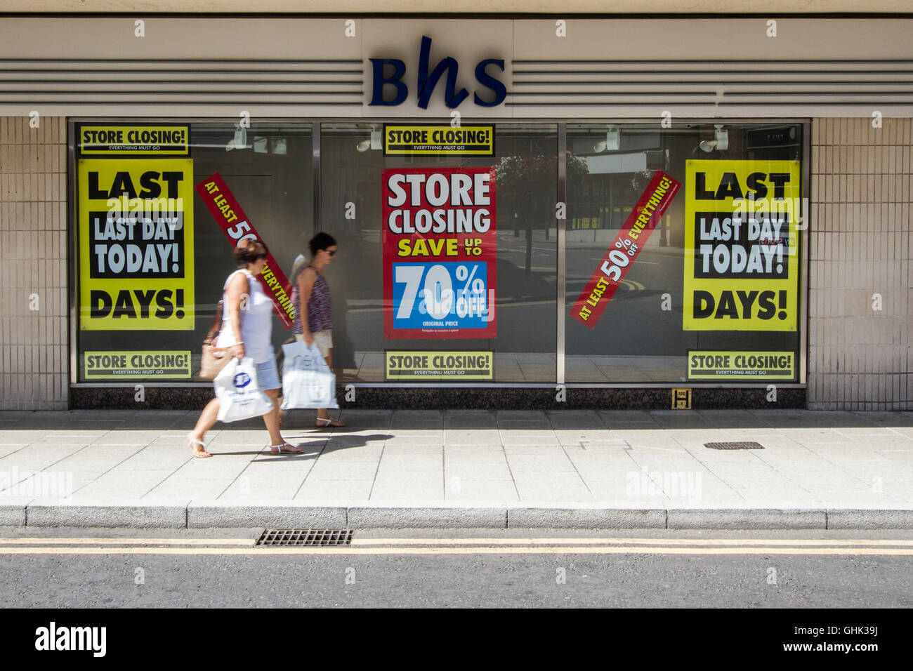 Shoppers walk past Woking's branch of British Home Stores (BHS) on the ...