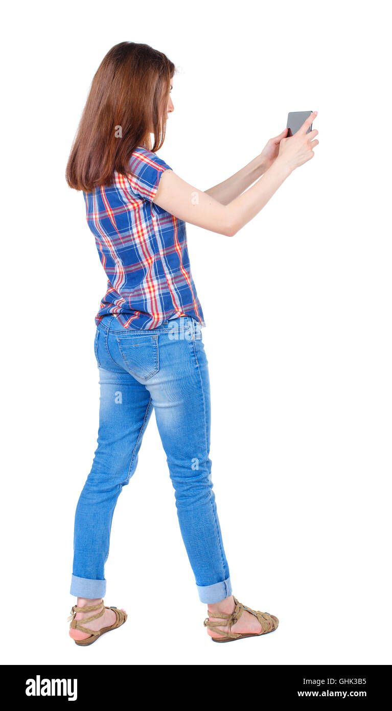 back view of standing young beautiful woman using a mobile pho Stock ...