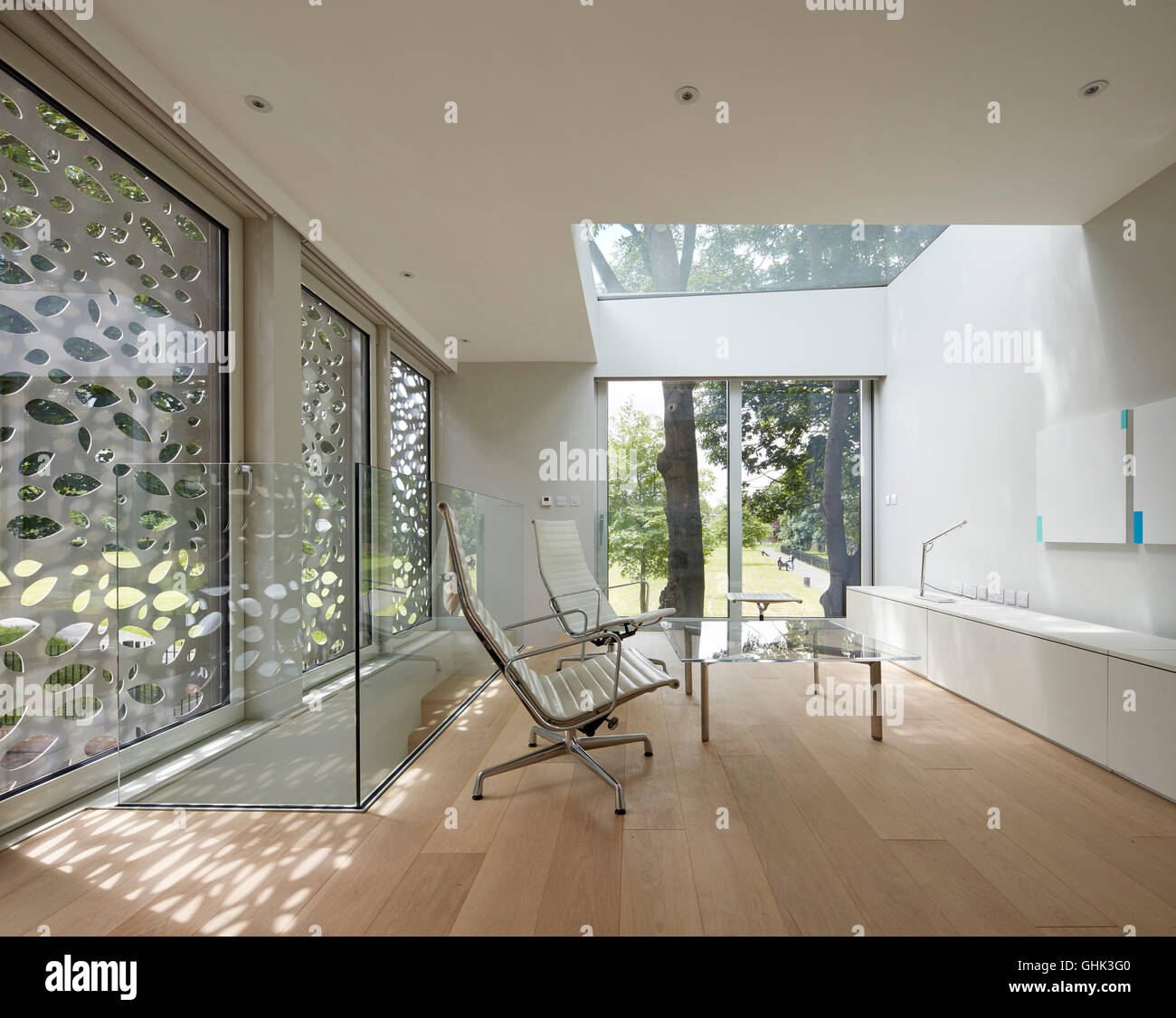 Living area with skylight and screened full-height windows. House in ...