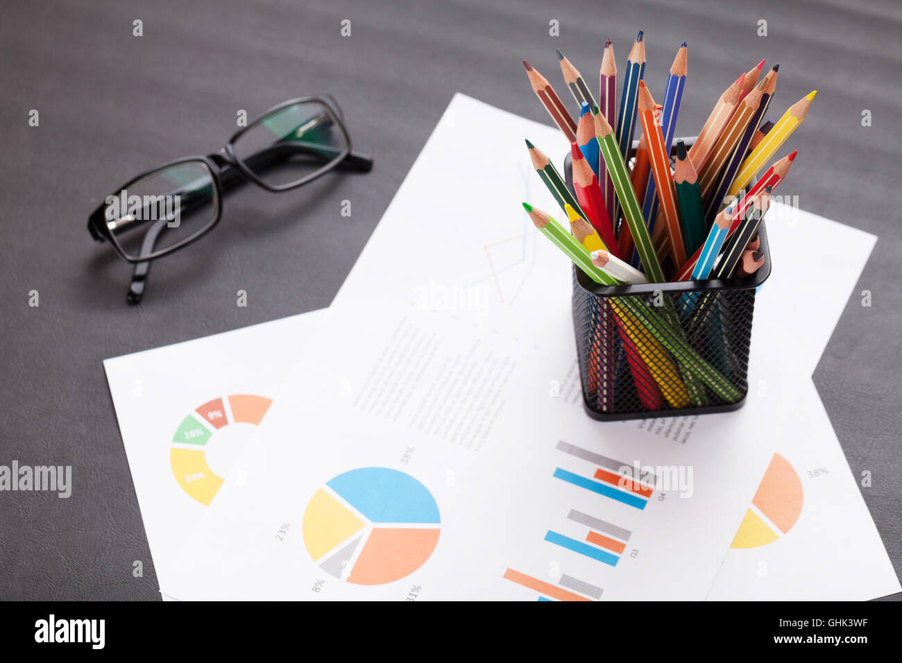 Office desk with charts and supplies on leather desk table Stock Photo ...