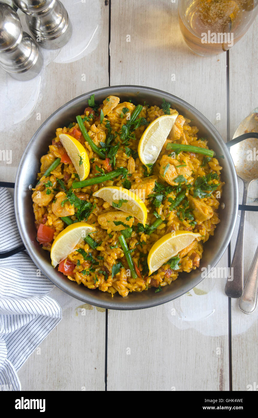 Spanish paella with rabbit, tomatoes and green beans Stock Photo - Alamy