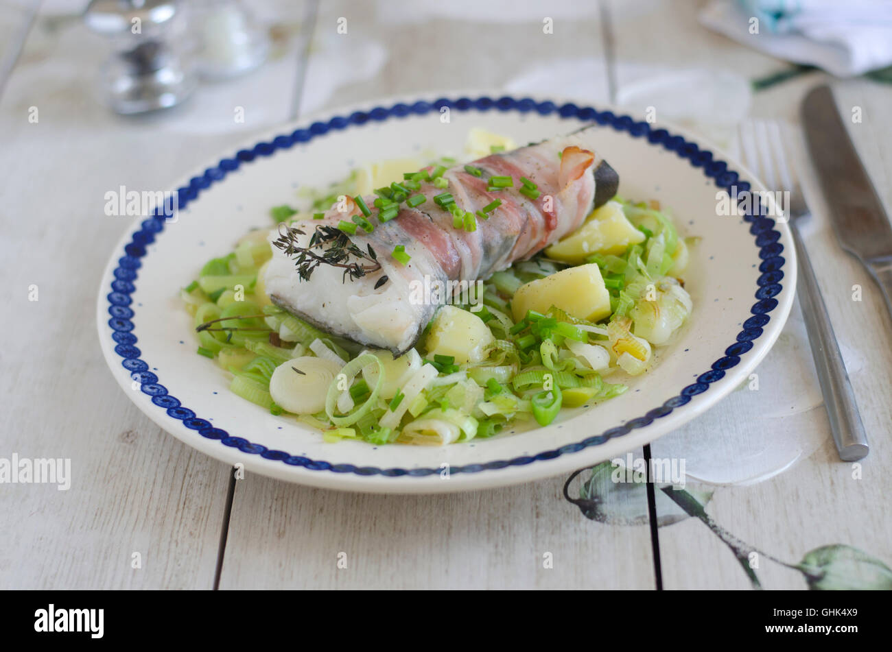 Haddock wrapped in Pancetta with potatoes and leeks Stock Photo - Alamy