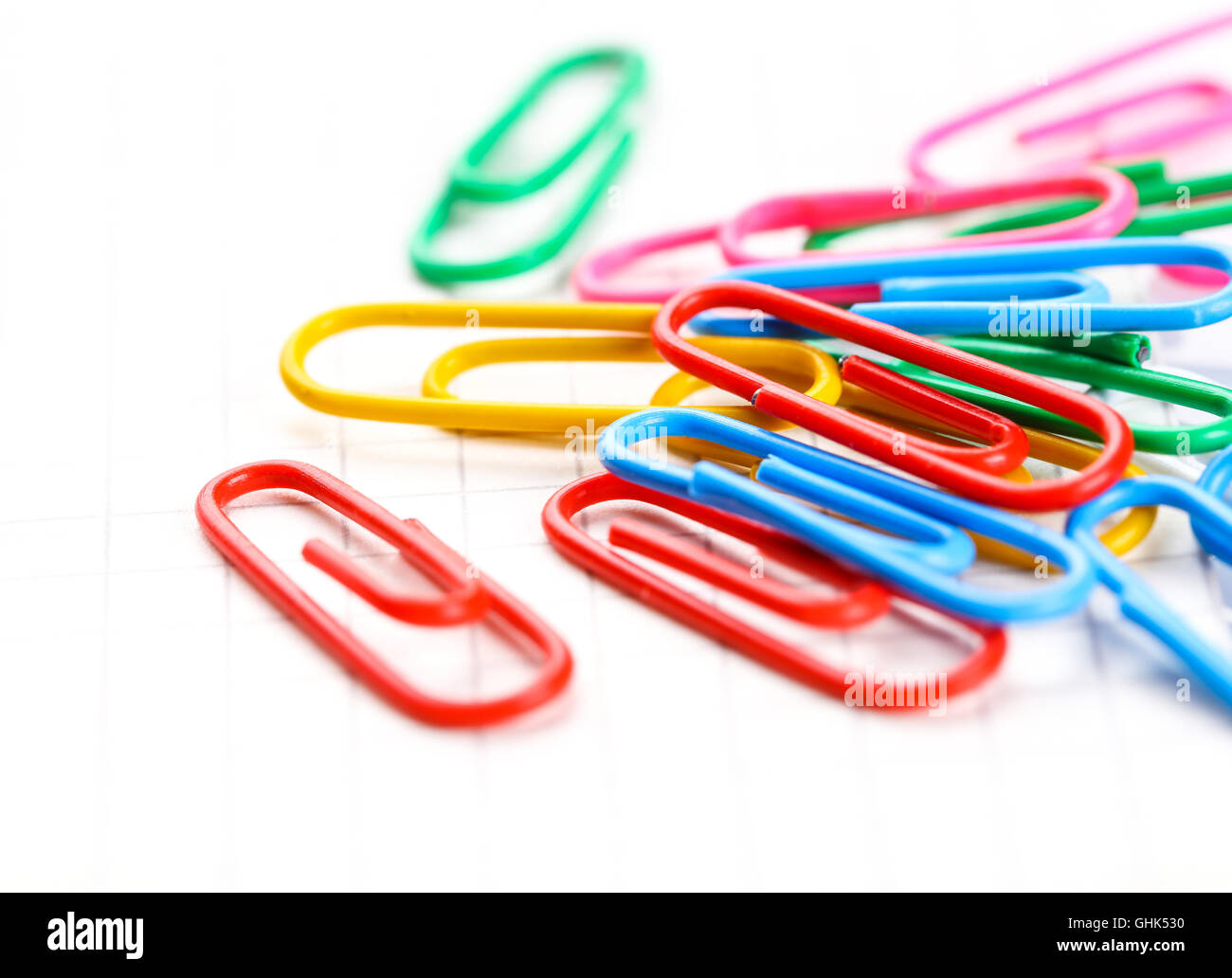 colored paper clips close-up on white background Stock Photo - Alamy