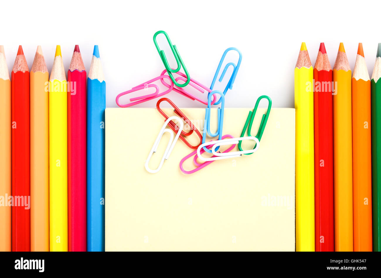 set of colored pencils and paper clips on a white background Stock ...