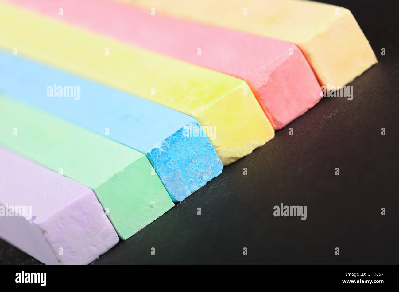 set of colored crayons on a black background Stock Photo - Alamy