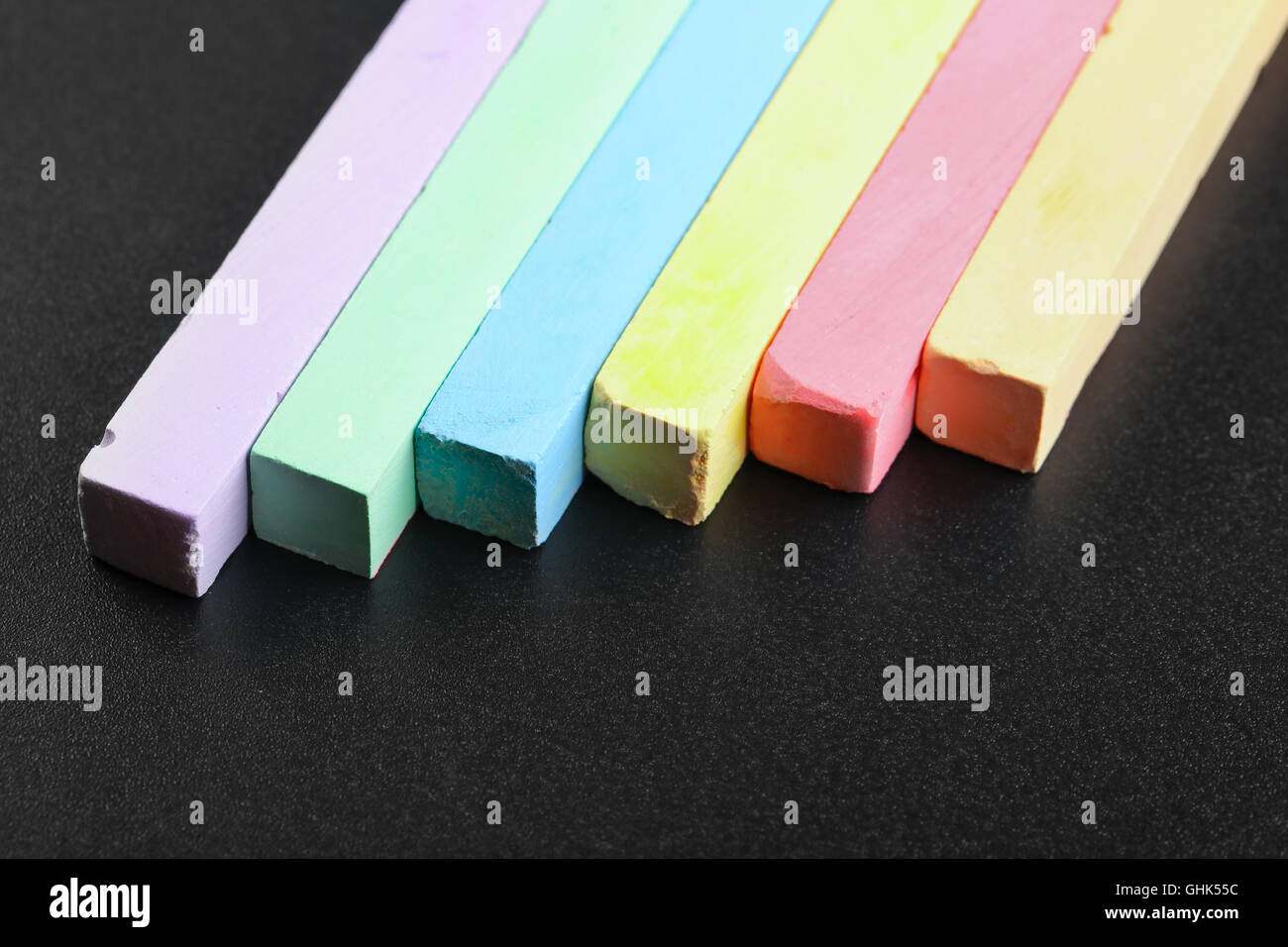 set of colored crayons on a black background Stock Photo - Alamy