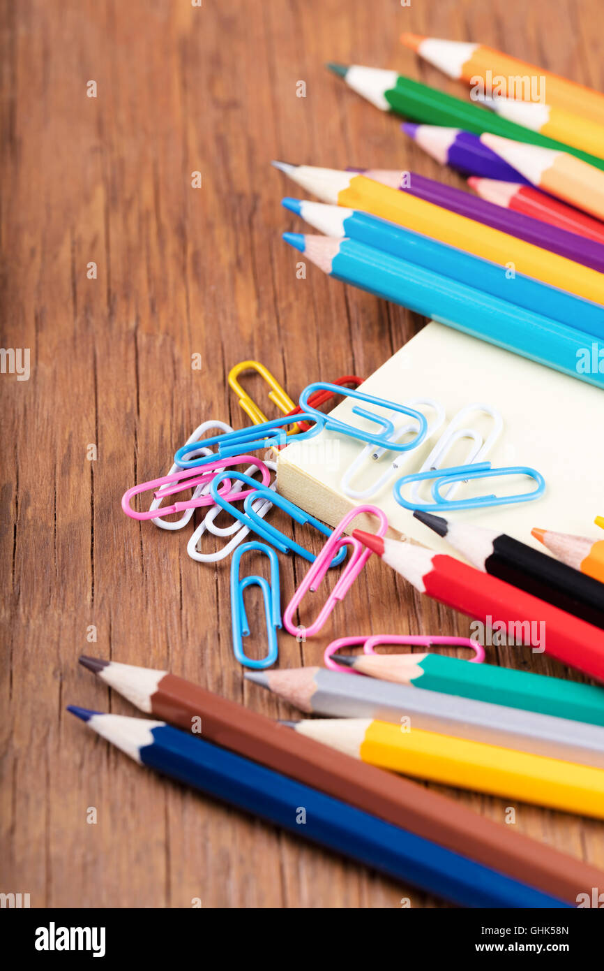 colored pencils and a notebook with paper clips Stock Photo - Alamy