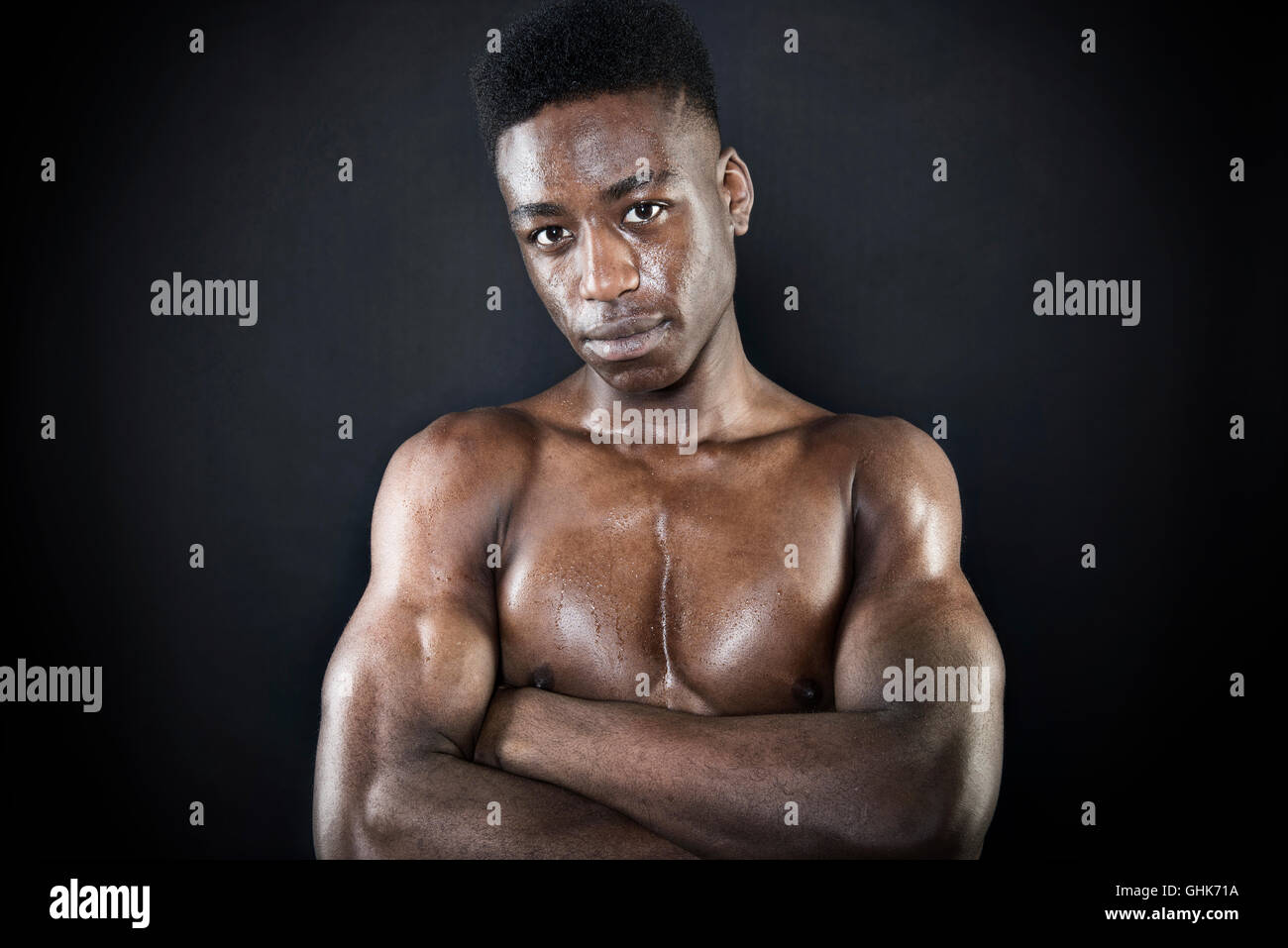 Sportsman athlete muscular sweating wet face and torso after exercise ...