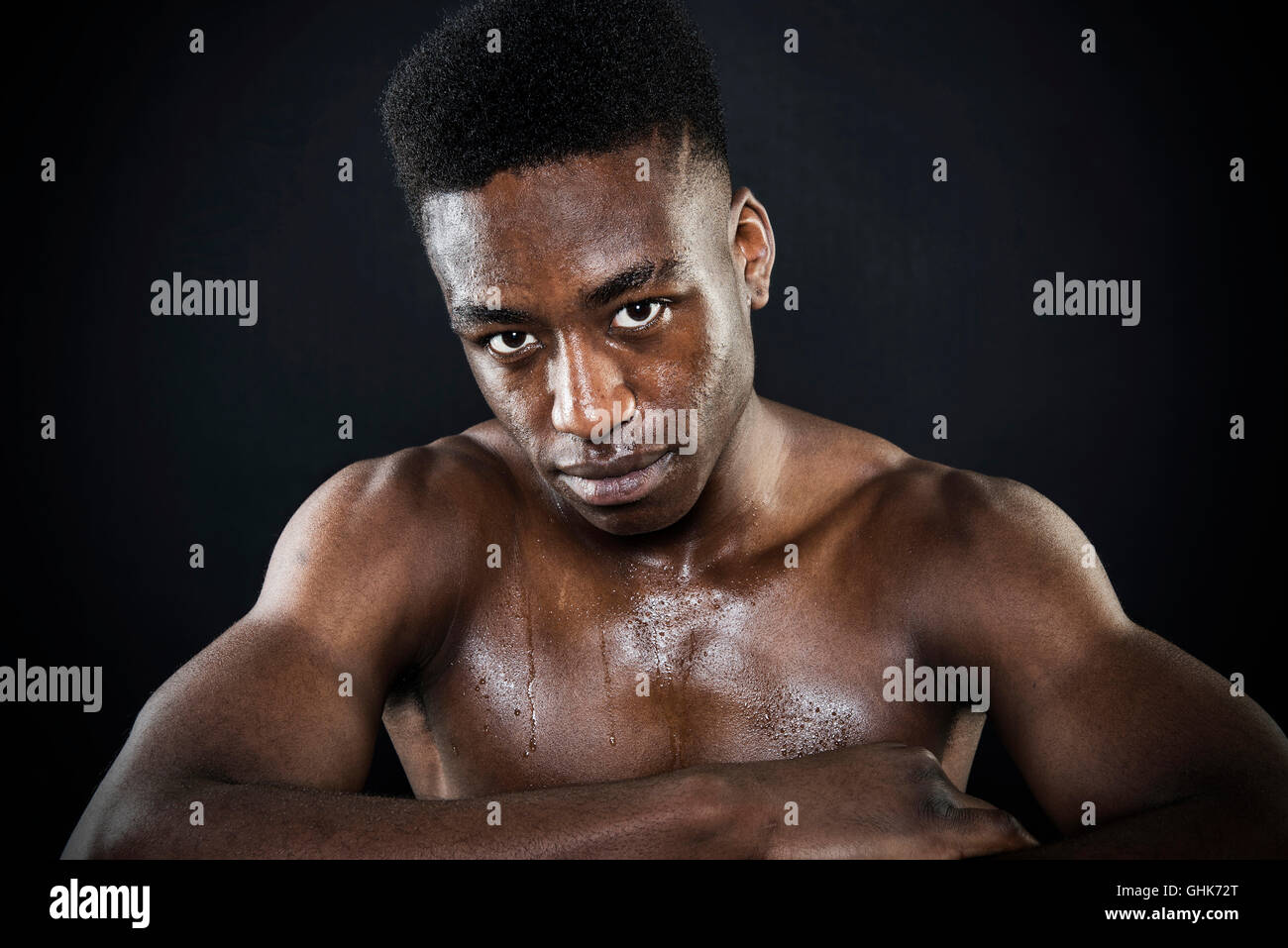 Sportsman athlete muscular sweating wet face and torso after exercise ...