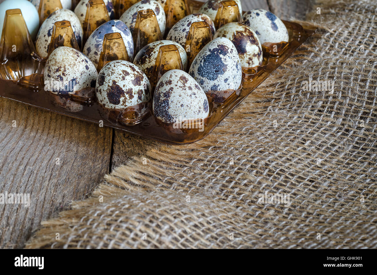 Quail eggs in a plastic stand on the old wooden background Stock Photo ...