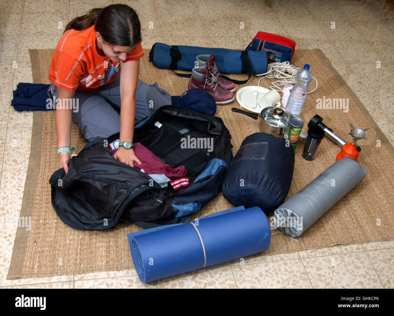 A young girl of 12 packing her backpack for a camping trip Stock Photo ...