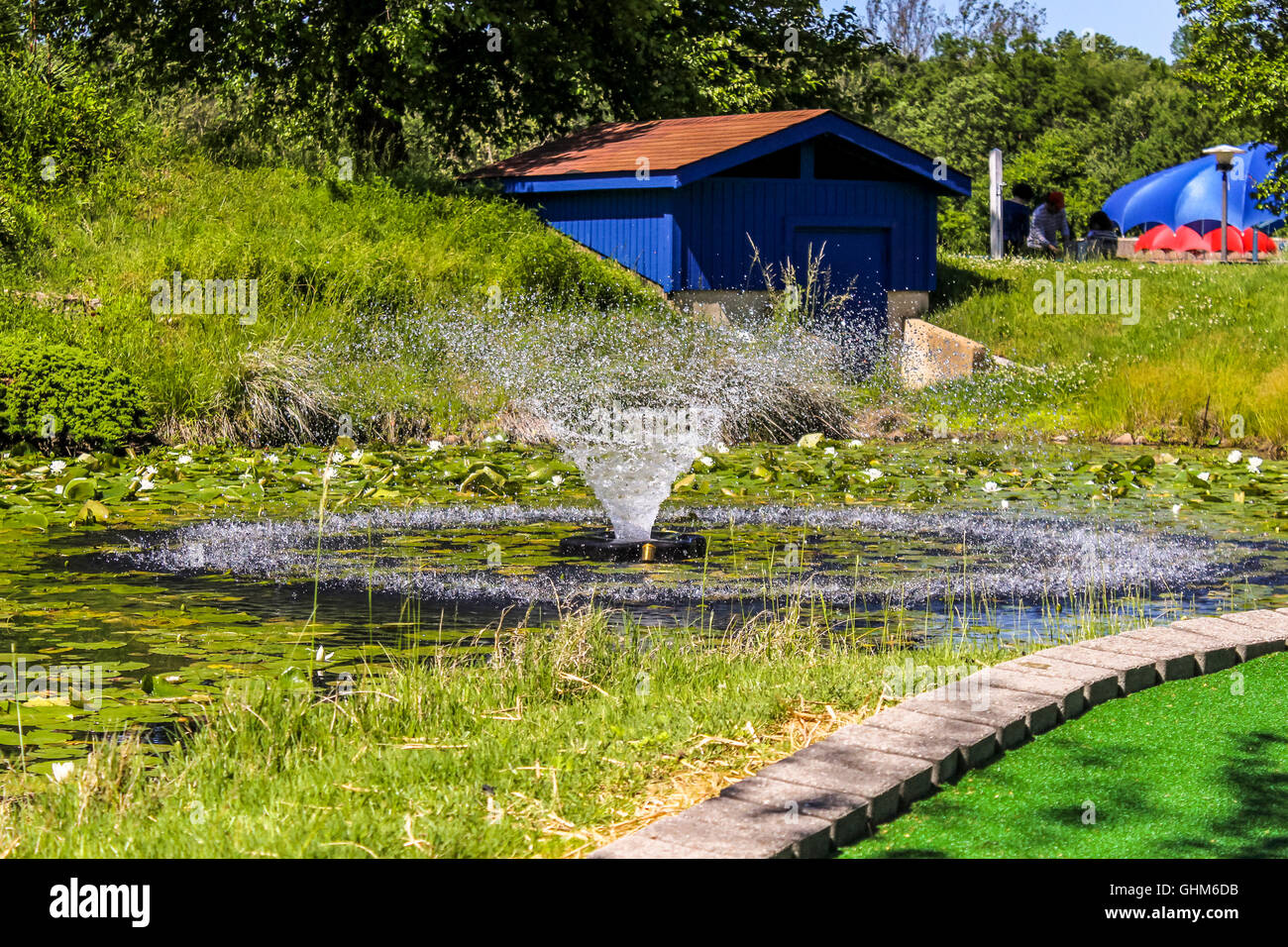 Water fountain circle on mini golf course Stock Photo - Alamy