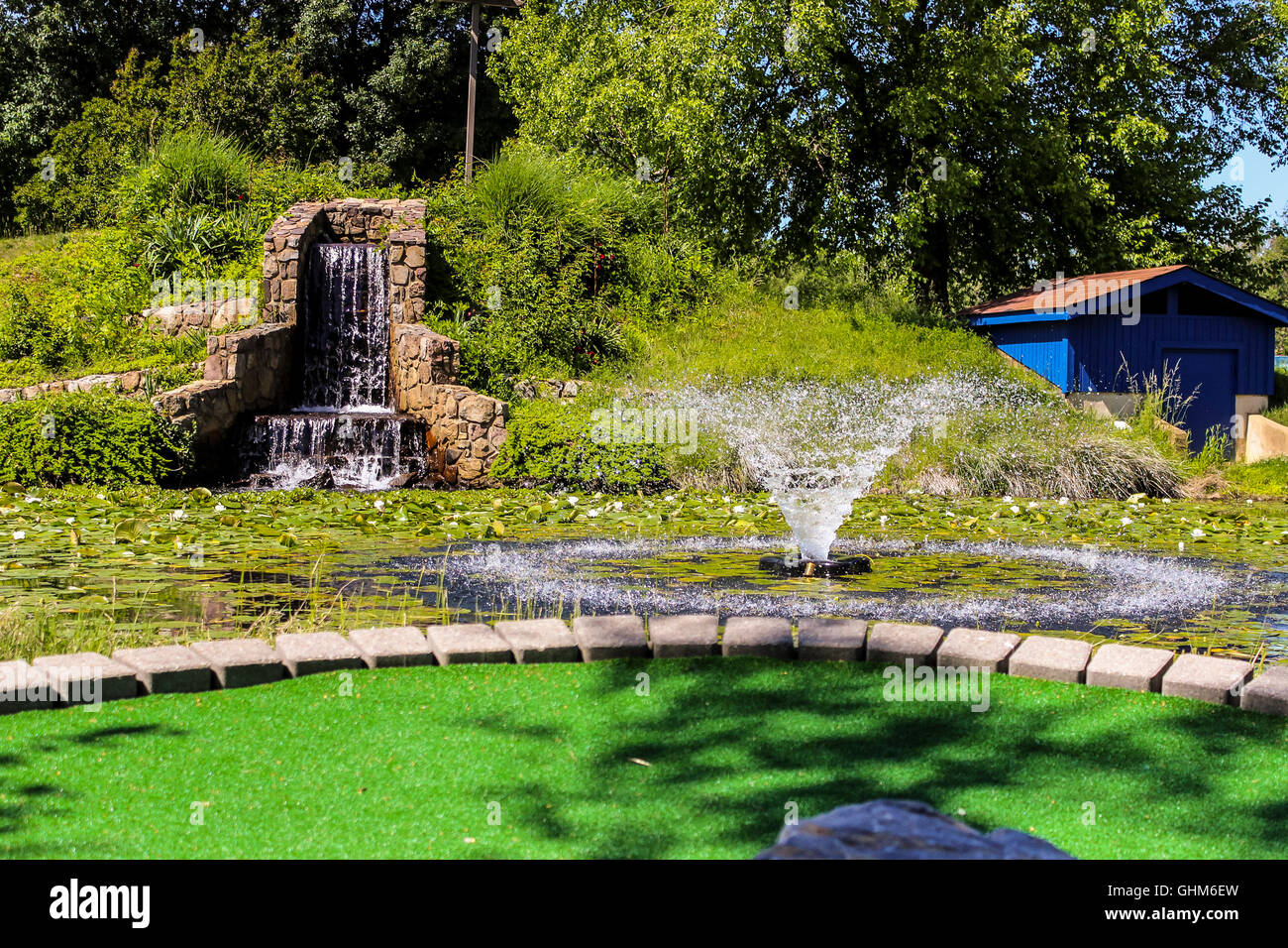 Water fountain circle on mini golf course Stock Photo - Alamy