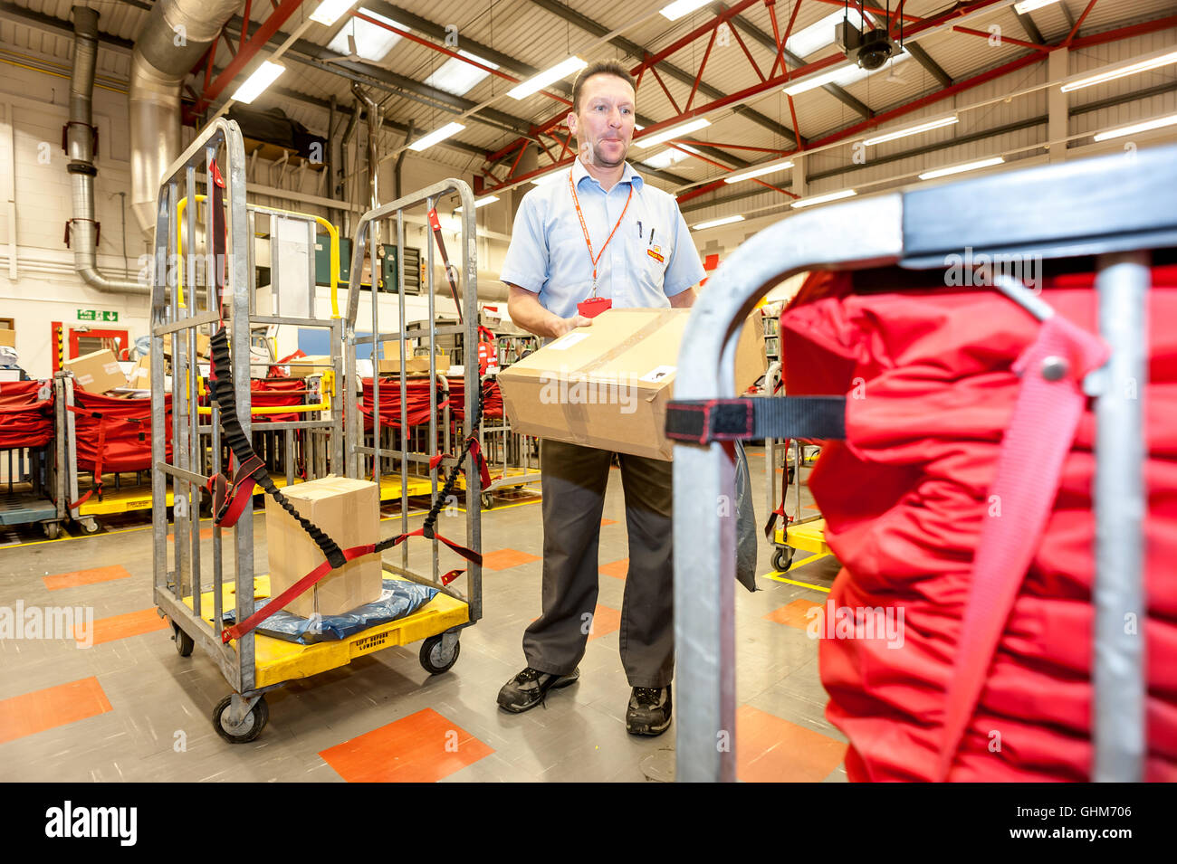 Postal workers sorting the mail in a sorting office in southern England ...