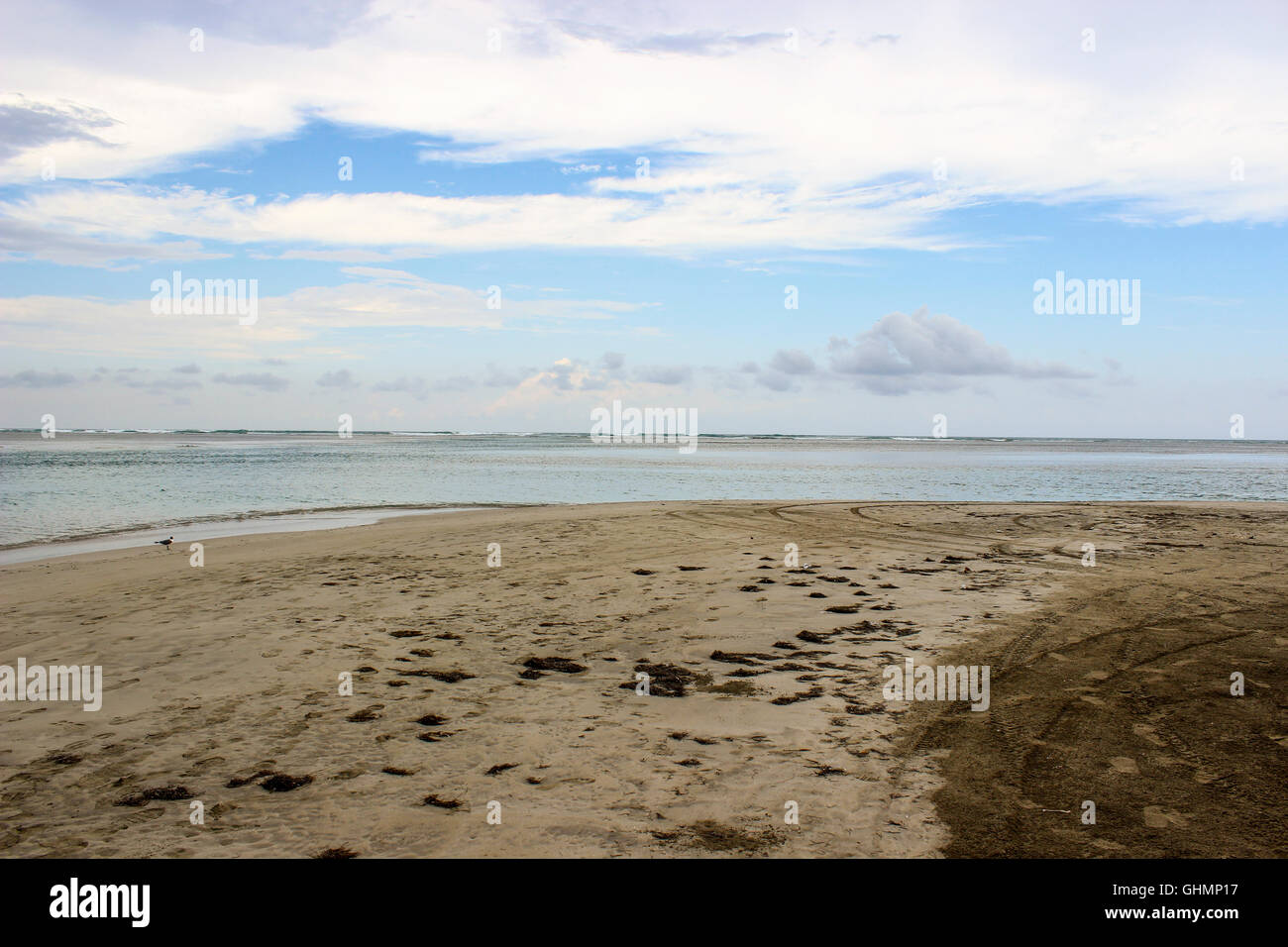 Sunset Lighting in the Clouds over Sea and Sandy Beach Stock Photo - Alamy