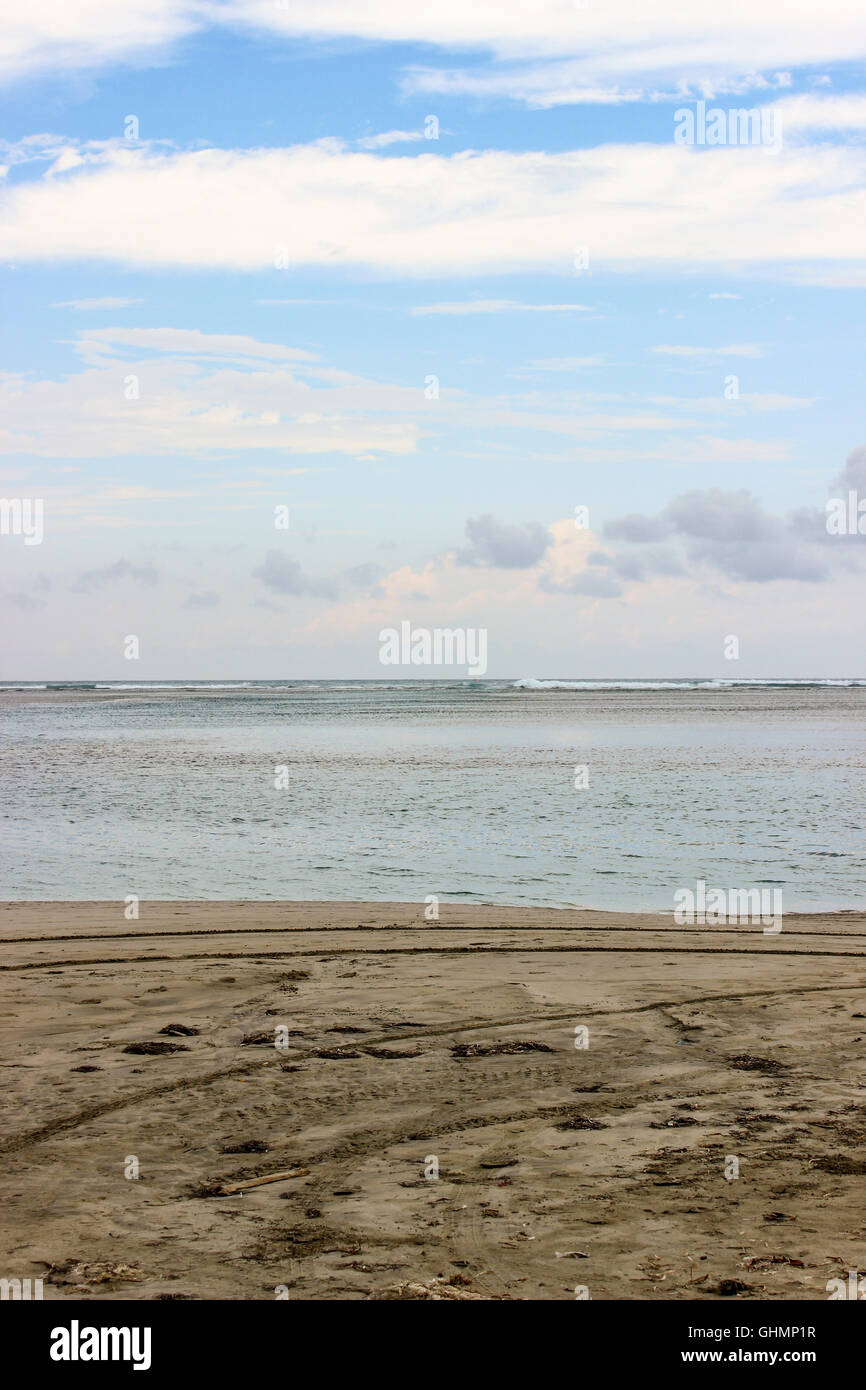 Sunset Lighting in the Clouds over Sea and Sandy Beach Stock Photo - Alamy