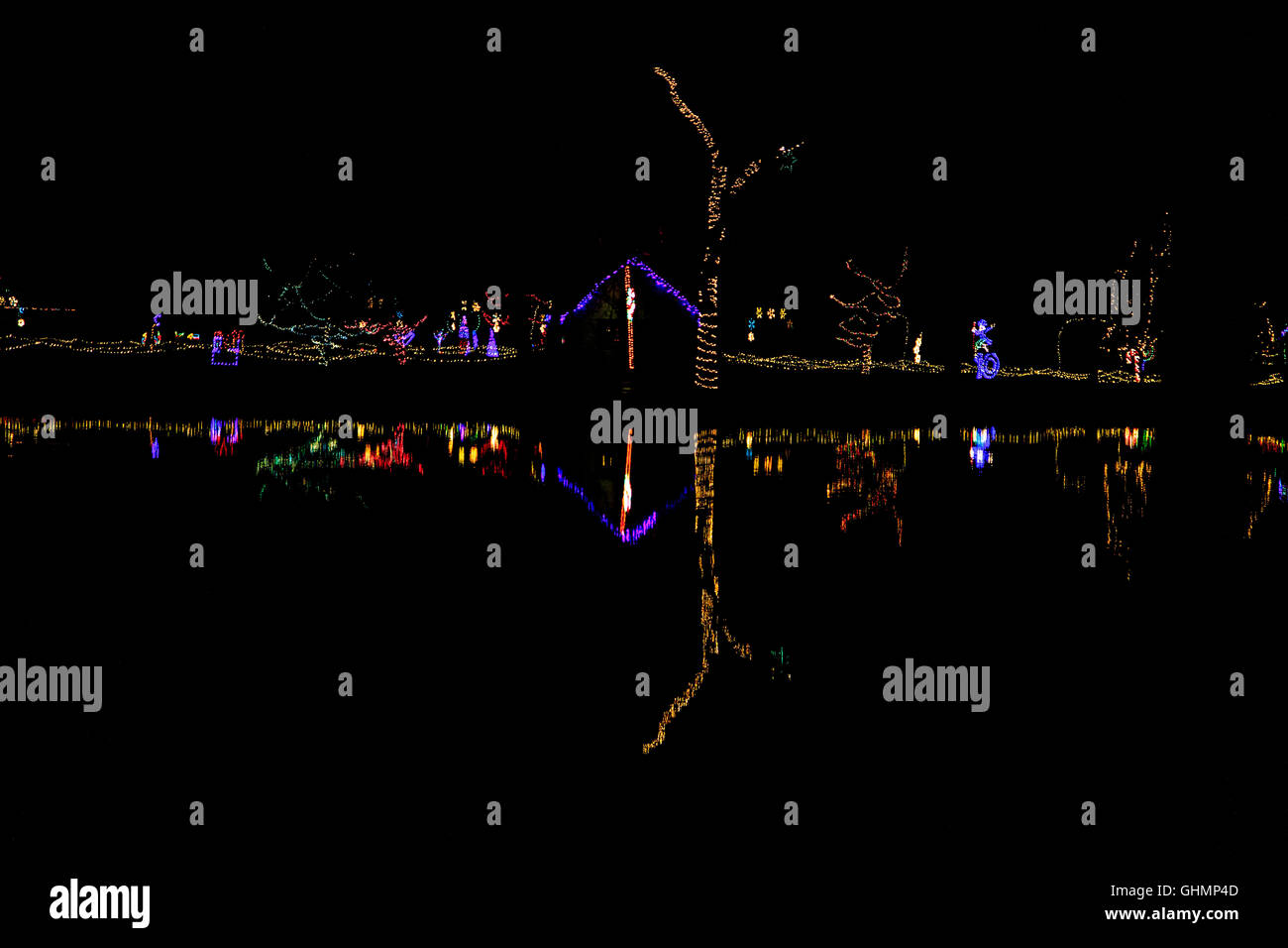Christmas Lights at Night with reflection in pond Stock Photo - Alamy