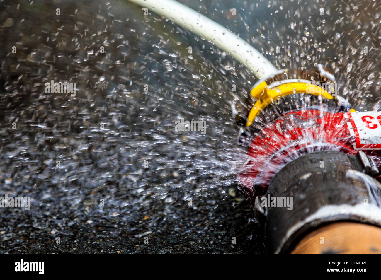 Water Spilling out of firehose connected to a regular hose Stock Photo ...